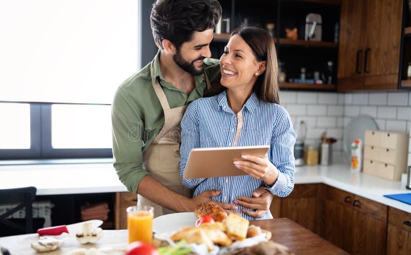 Happy Couple Cooking Together in Their Kitchen Stock Image - Image of ...