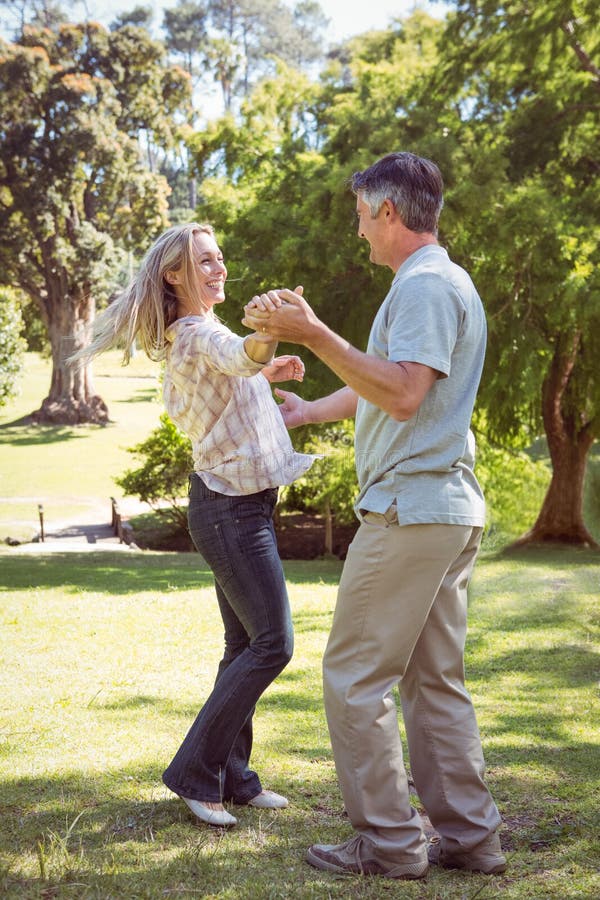 Happy Couple Dancing in the Park Stock Photo - Image of relationship ...
