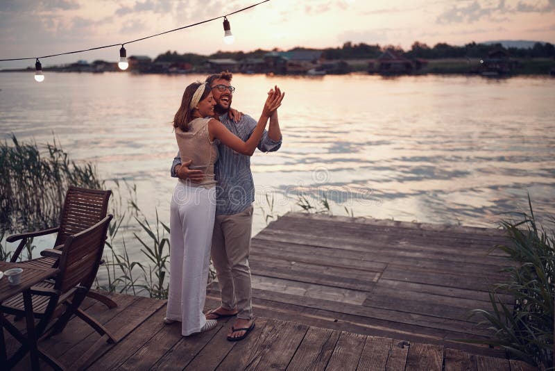 Happy Couple Dancing by the River at Sunset Stock Photo - Image of ...