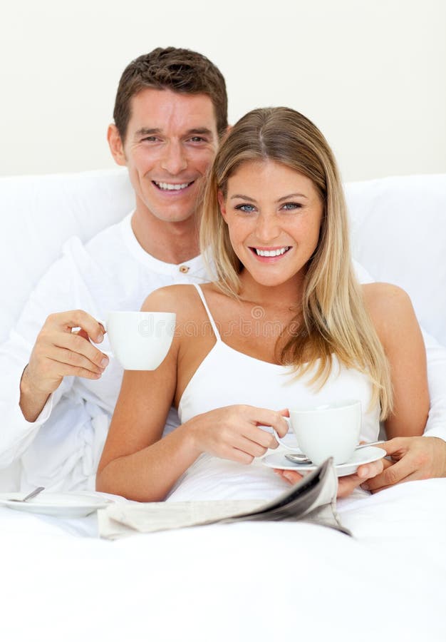 Happy Couple Drinking Coffee Lying on Their Bed Stock Image - Image of ...