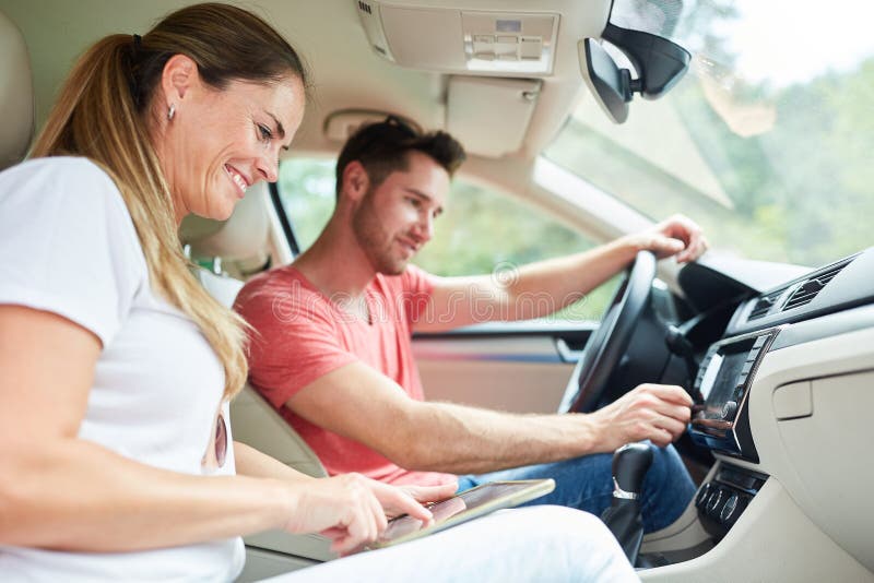 Couple Driving with Tablet Computer Stock Image - Image of woman, drive ...