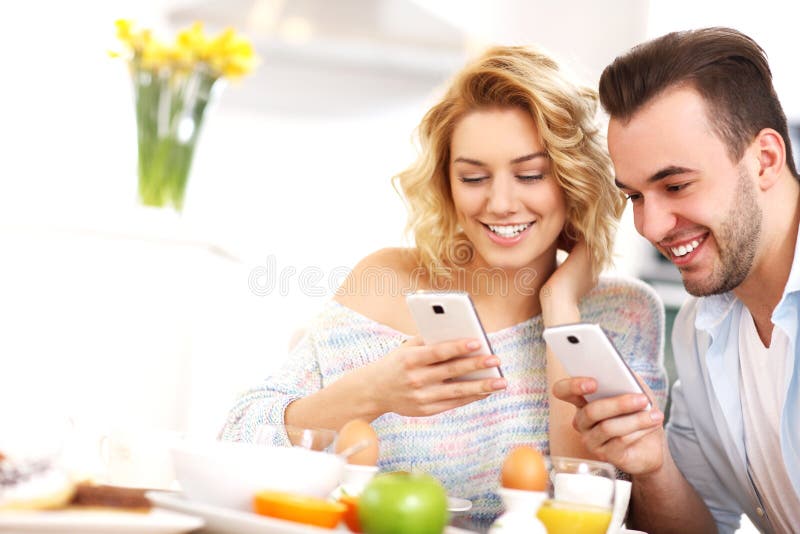 Happy Couple Eating Breakfast and Using Smart Phone Stock Image - Image ...
