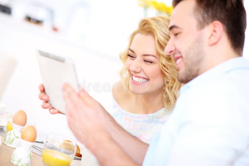 Happy Couple Eating Breakfast and Using Tablet Stock Image - Image of ...