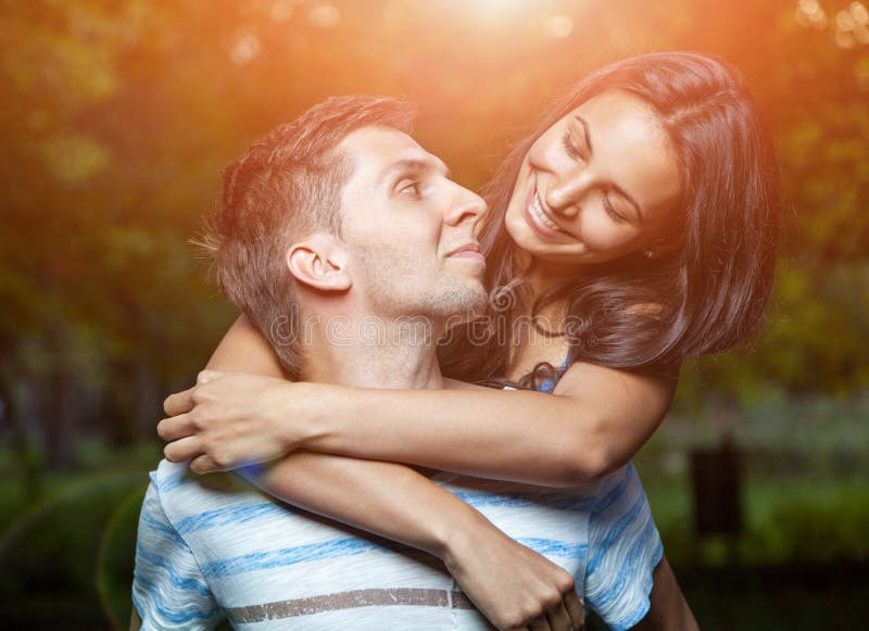Happy Couple Embracing in the Park Stock Photo - Image of outdoors ...