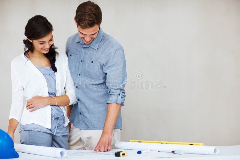 Happy Couple Going through House Plan. Portrait of Happy Young Couple ...