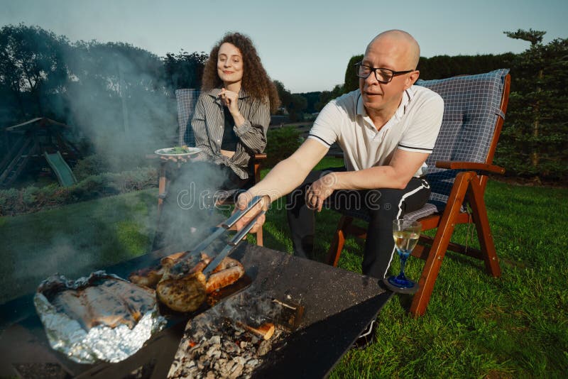 Happy Couple Grilling at Backyard Stock Photo - Image of clink, people ...