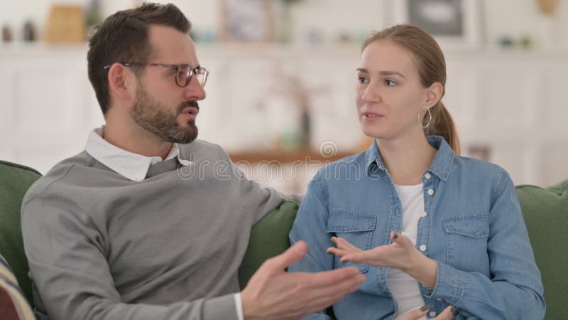 Happy Couple Having Conversation while Sitting on Sofa Stock Image ...