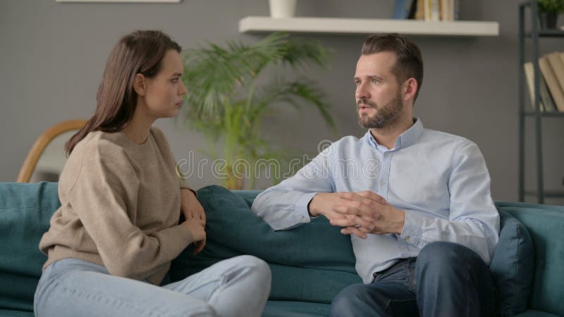 Happy Couple Having Conversation while Sitting on Sofa Stock Photo ...