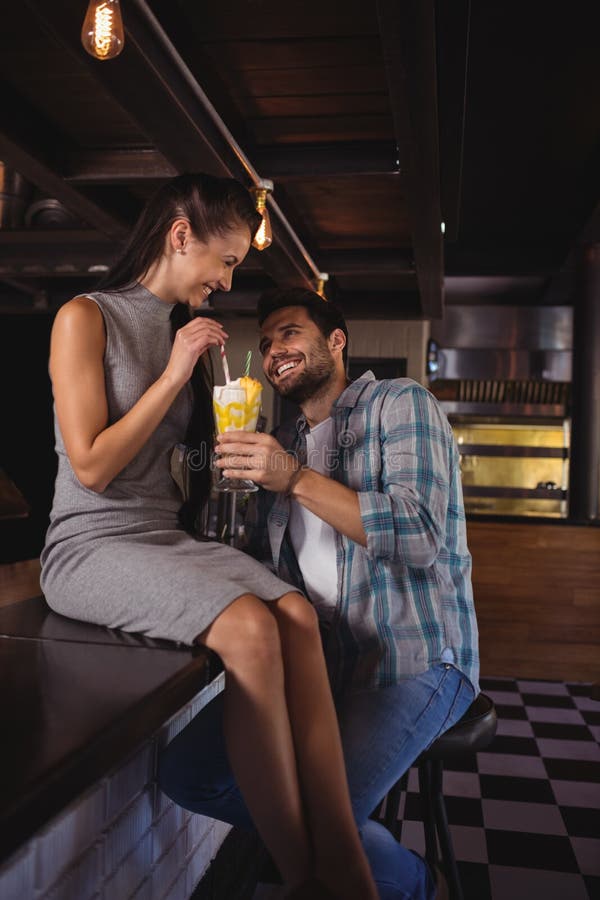 Happy Couple Having Milkshake Stock Photo - Image of indoors, glass ...
