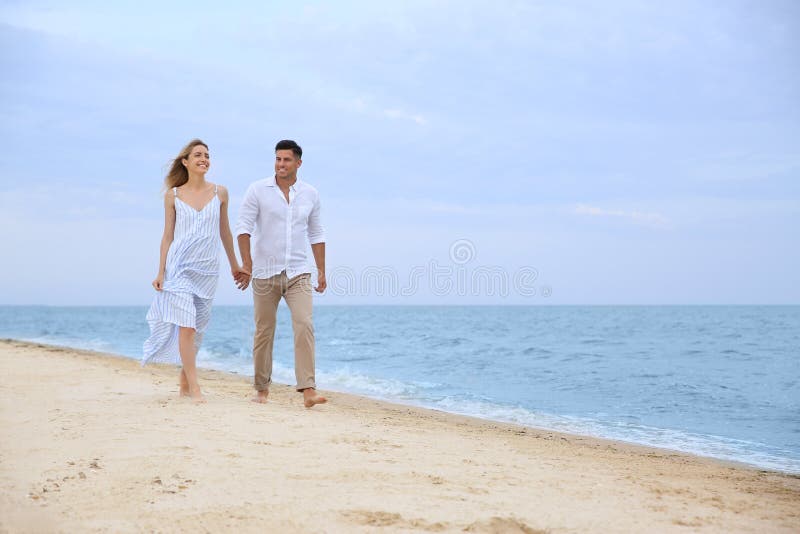 Couple Having Romantic Walk on Beach. Space for Text Stock Photo ...