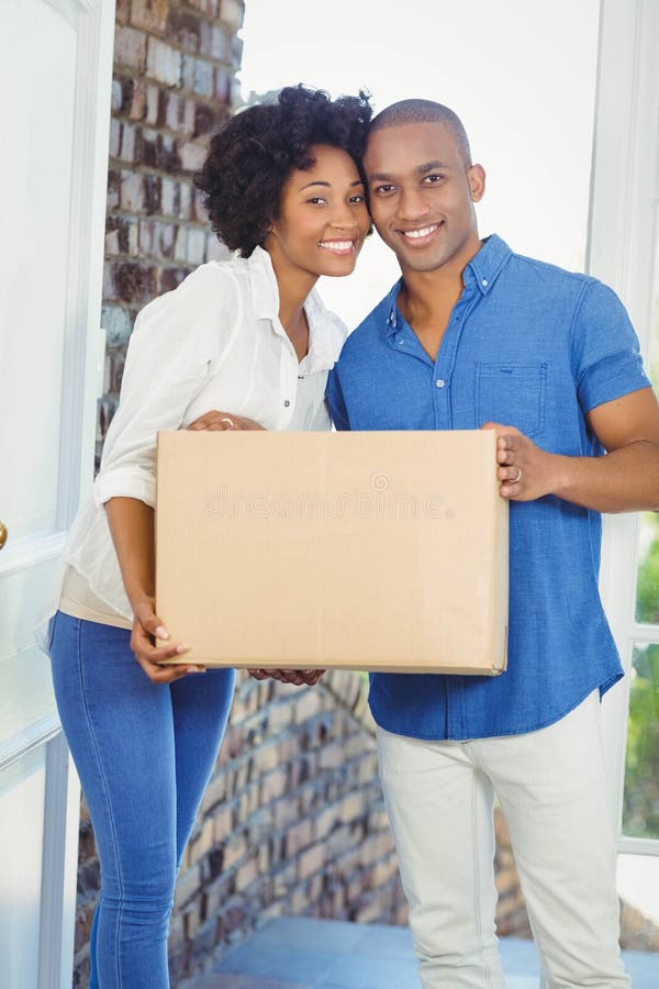 Happy couple holding box stock image. Image of homey - 66930845