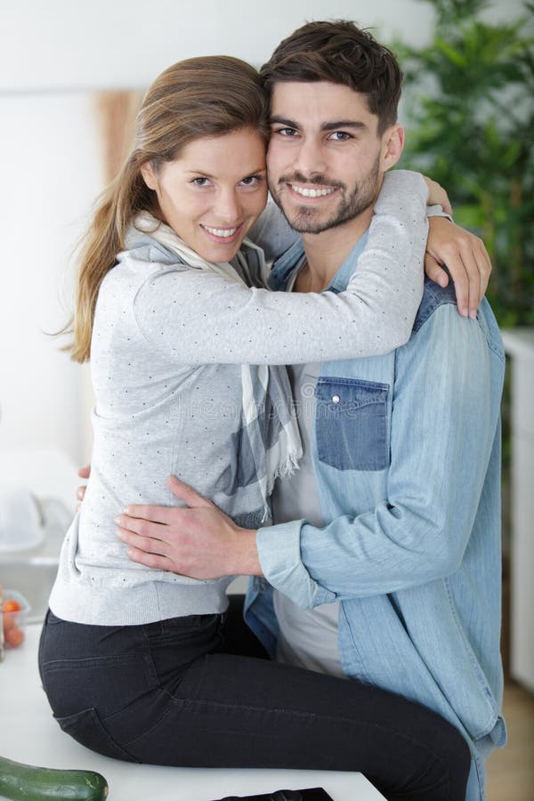 Happy Couple Hugging in Kitchen Stock Photo - Image of indoors, hugging ...