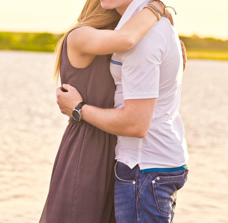 Happy Couple Hugging while Standing on the Bank of Stock Photo - Image ...