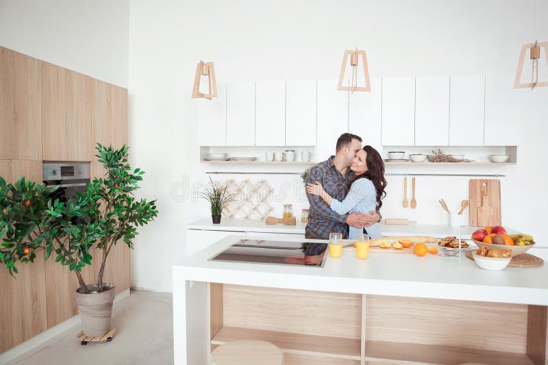 Happy Couple Hugging in the White Loft Stile Kitchen Stock Photo ...