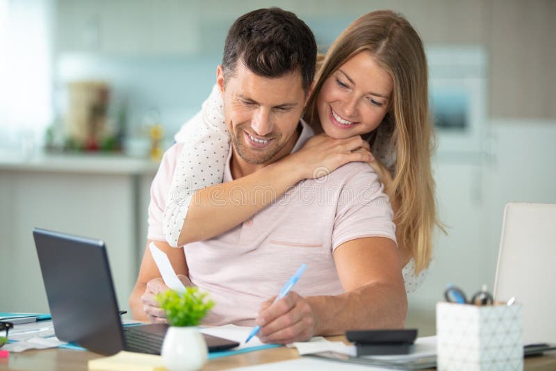 Happy Couple Hugging and Working Together at Home Stock Image - Image ...