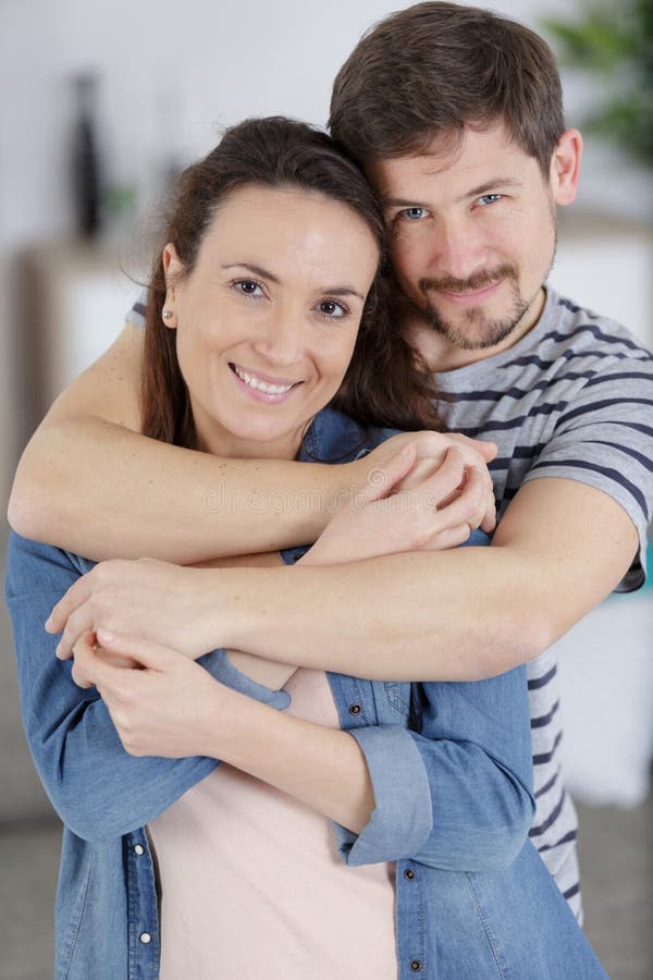 Happy Couple Hugging and Working Together at Home Stock Image - Image ...