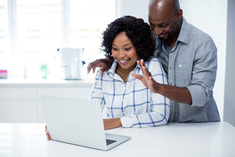 Happy Couple Interacting with Each Other while Using Laptop Stock Image ...