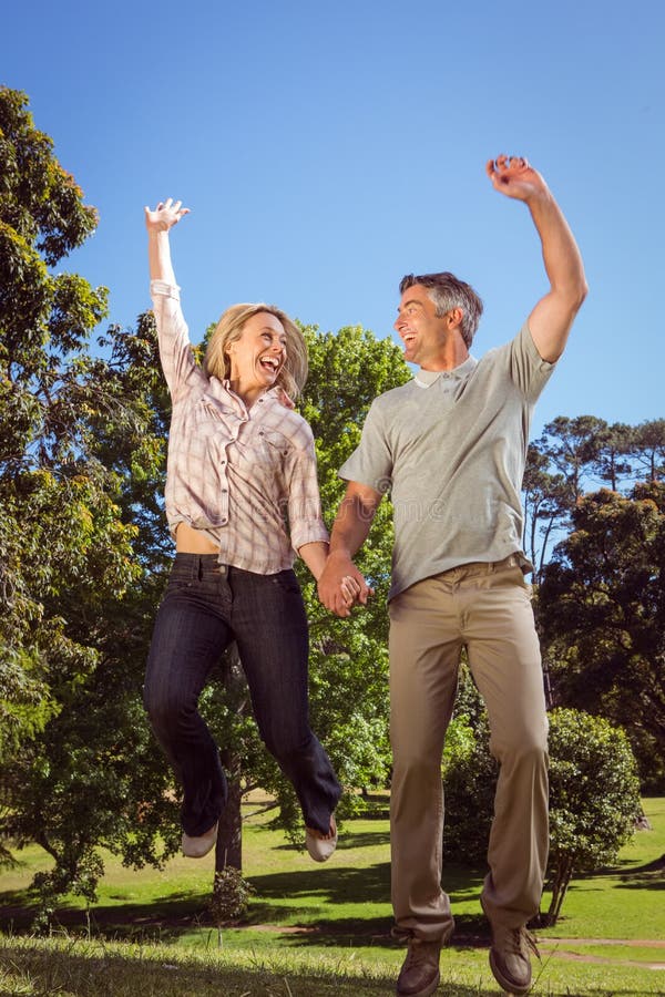 Happy Couple Jumping in the Park Stock Image - Image of nature, mature ...
