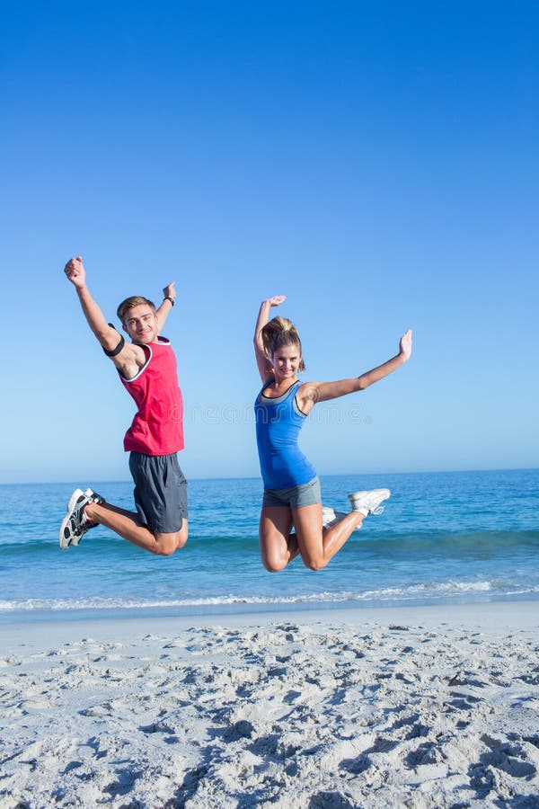 Happy Couple Jumping Together Stock Image - Image of outdoors ...