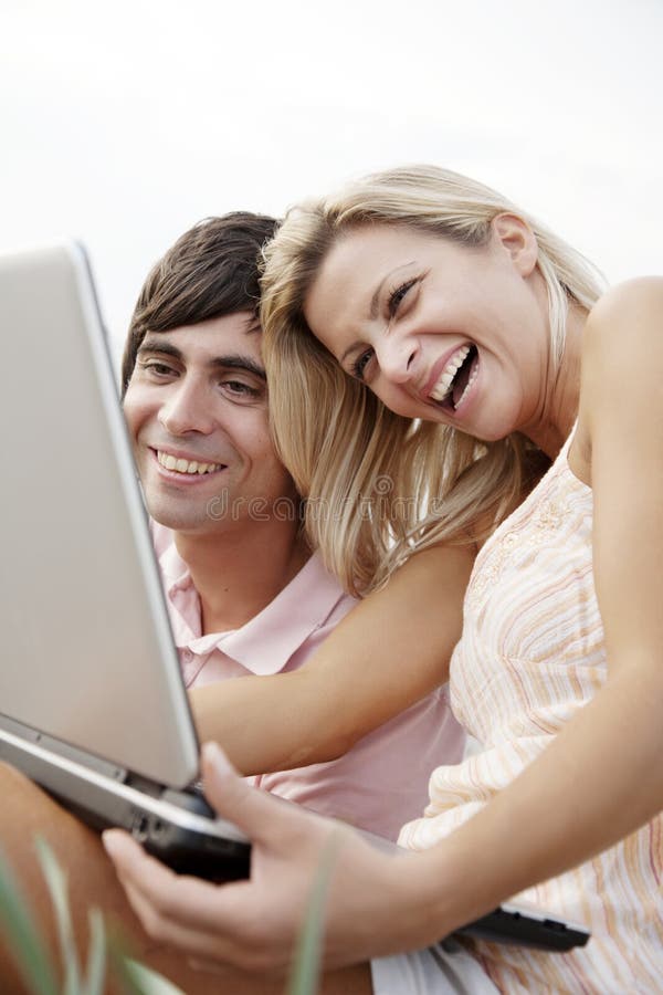 Summer couple using laptop stock image. Image of computer - 19009909