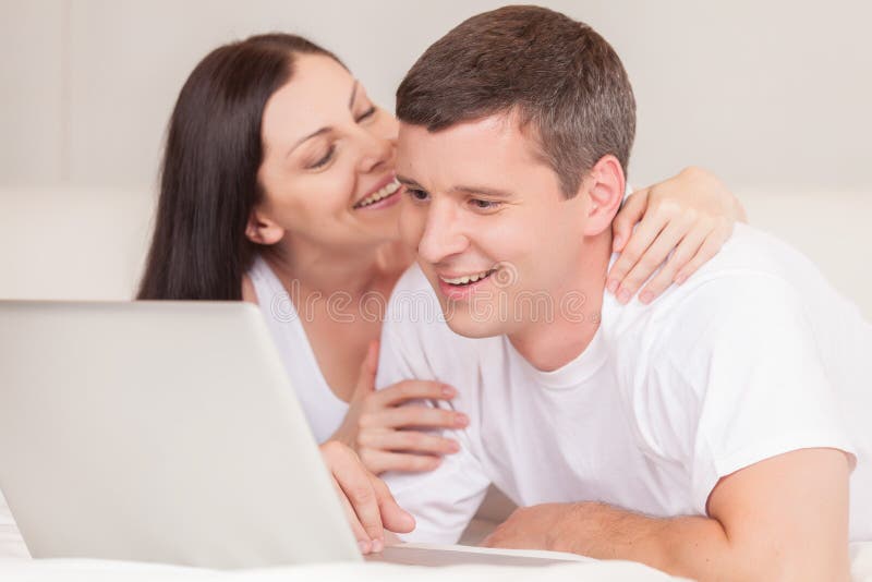 Happy Couple with Laptop in Bed Smiling. Stock Image - Image of ...