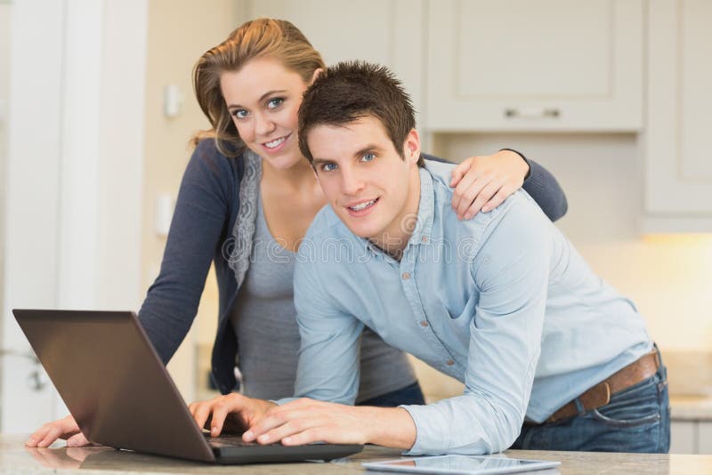Couple with Laptop and Bill in the Kitchen Stock Photo - Image of side ...