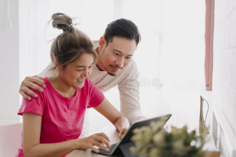 Happy Couple Looking at the Advertisement Service Offer in the Internet ...