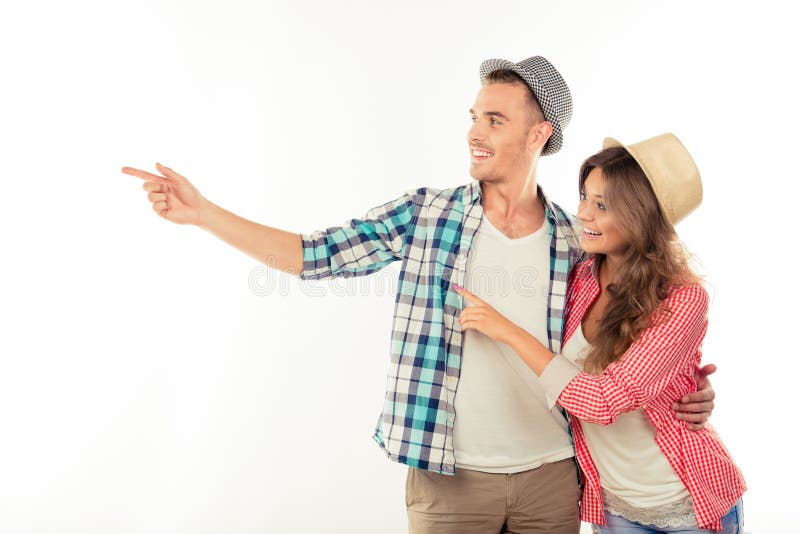 Happy Couple in Love with Hats Pointing Away Stock Image - Image of ...