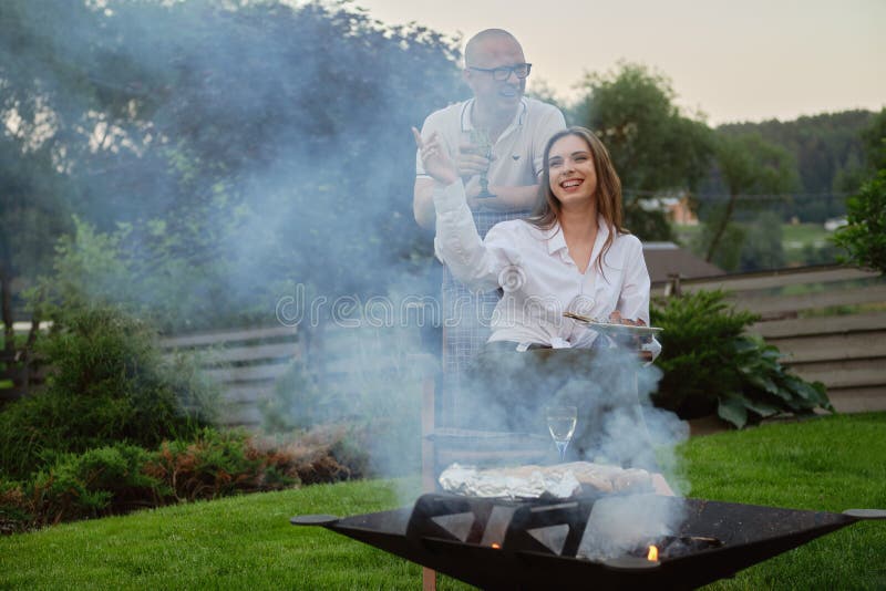Happy Couple Making Barbecue on Backyard Stock Photo - Image of evening ...