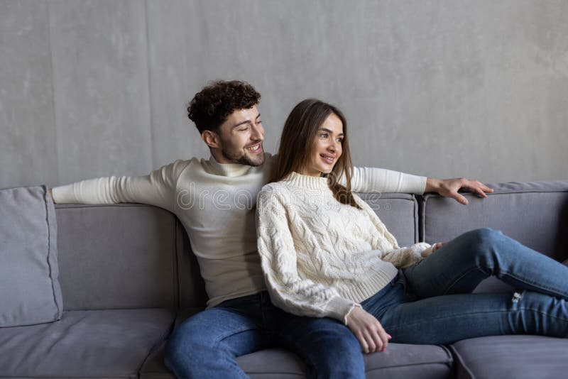 Happy Young Couple or Marriage Hugging and Enjoying in a Couch at Home ...