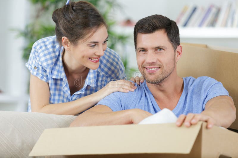 Happy Couple Moving in New Home Unpacking Boxes Stock Photo - Image of ...