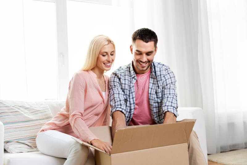 Happy Couple with Open Parcel Box at Home Stock Photo - Image of ...