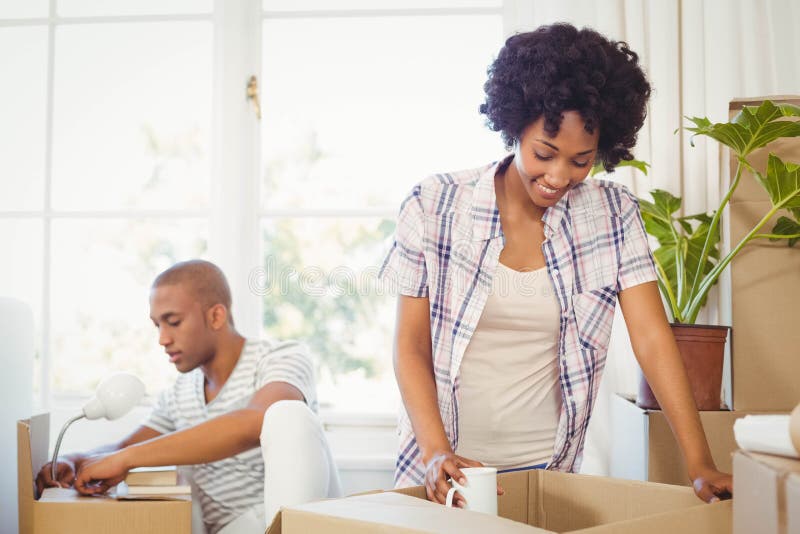 Happy couple opening boxes stock photo. Image of estate - 66930890