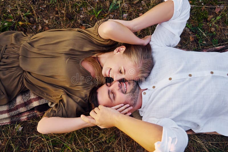 Happy Couple is Outdoors Laying Down on the Ground Stock Photo - Image ...