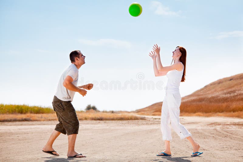 Happy Couple Playing with a Ball Stock Image - Image of casual, action ...