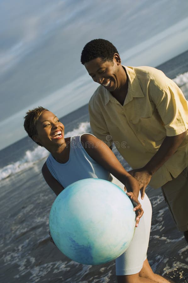 Happy Couple Playing with Beach Ball Stock Image - Image of holiday ...