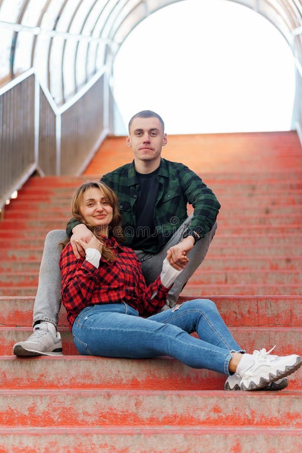 A Happy Couple Relaxing Together on Bright Red Stairs Stock Photo ...
