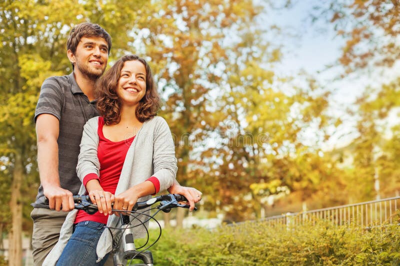 Happy Couple Riding on a Same Bike Stock Image - Image of cycling ...