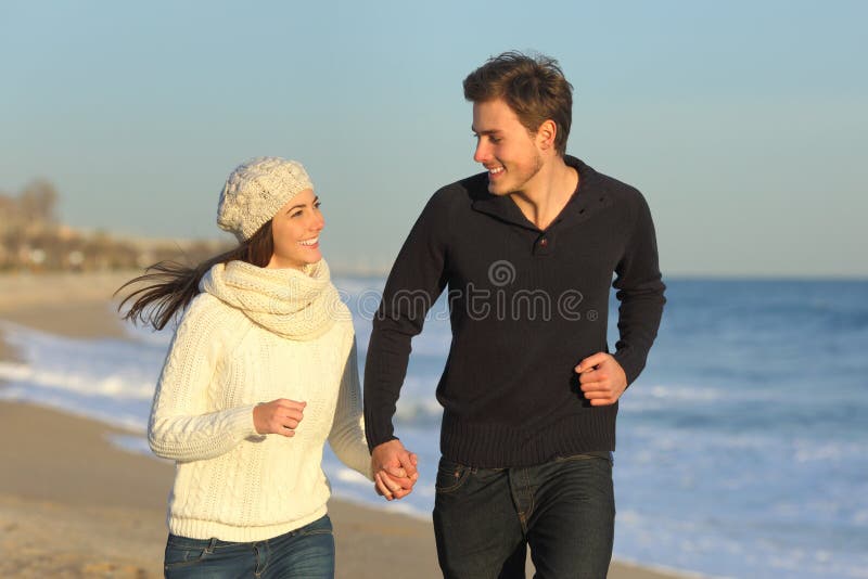 Happy Couple Running Together on the Beach in Winter Stock Image ...