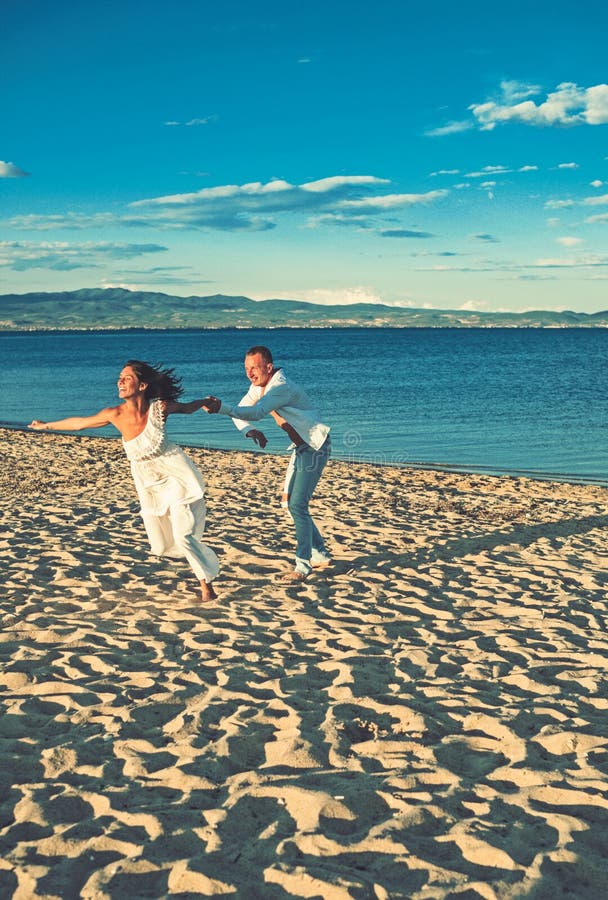 Happy Couple Running on Tropical Beach at Sunset, Vacation. Stock Photo ...