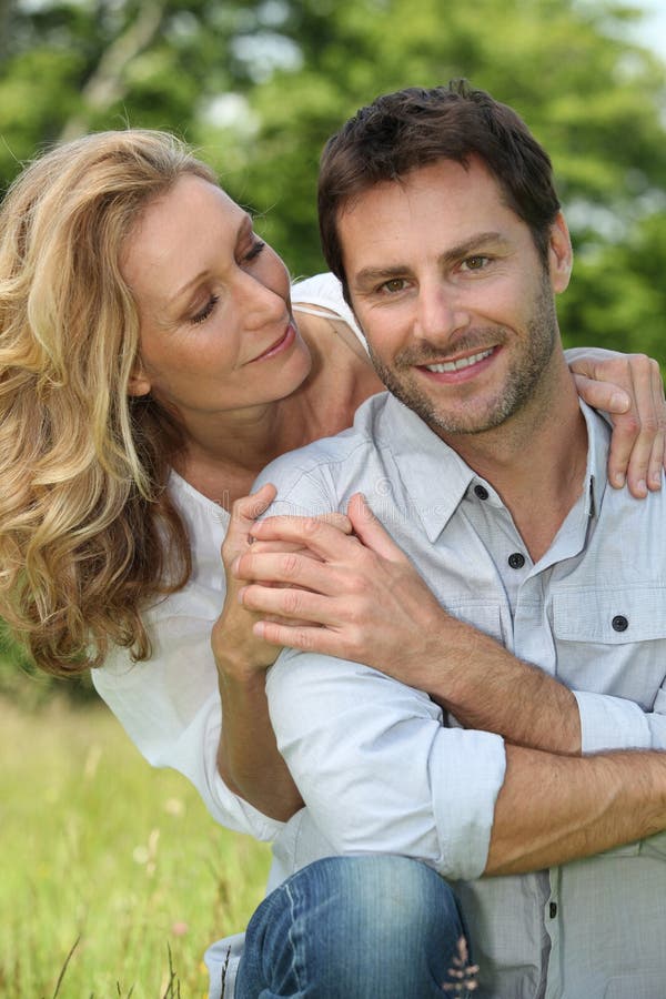 Happy Couple Smiling at Beach Stock Photo - Image of happy, young ...