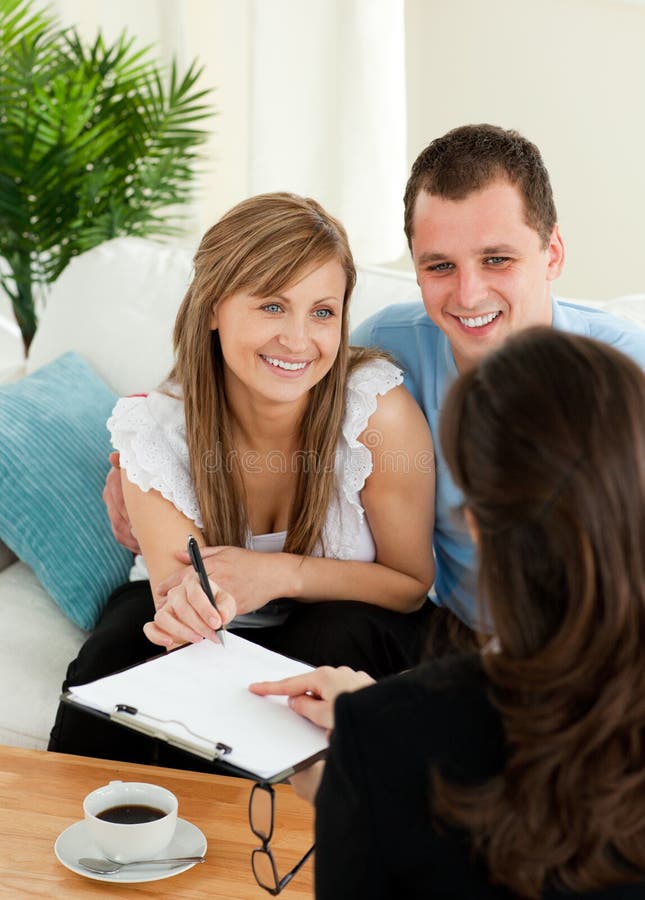 Happy Couple Signing a Contract Stock Image - Image of joyful, home ...