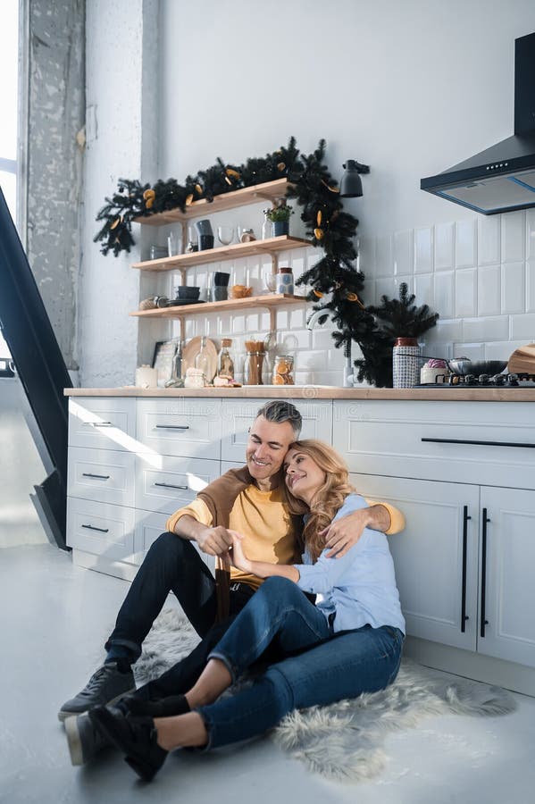 A Happy Couple Sitting in the Kitchen and Looking Joyful Stock Image ...