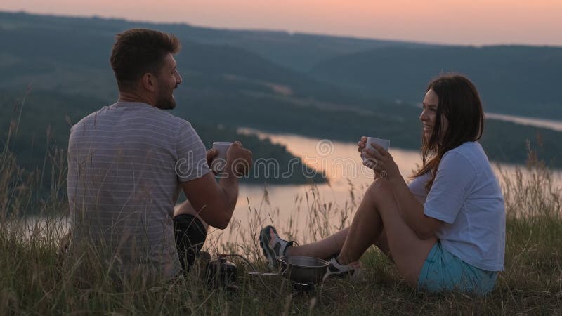 The Happy Couple Sitting on Mountain Top and Drinking Tea. Stock Image ...
