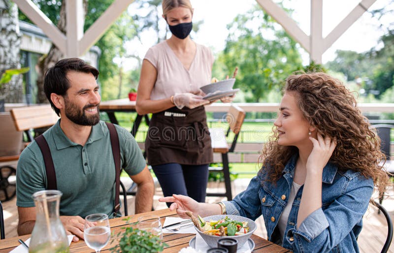 Happy Couple Sitting Outdoors on Terrace Restaurant, Eating. Stock ...