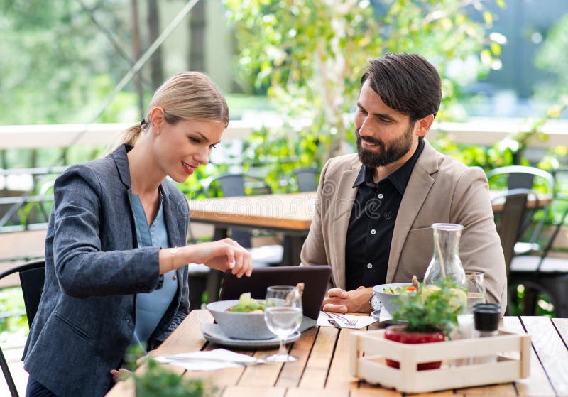 Happy Couple Sitting Outdoors on Terrace Restaurant, Eating. Stock ...
