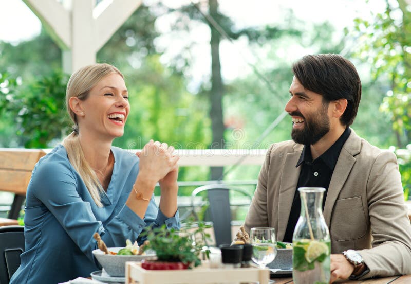 Happy Couple Sitting Outdoors on Terrace Restaurant, Talking. Stock ...