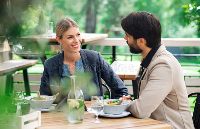 Happy Couple Sitting Outdoors on Terrace Restaurant, Talking. Stock ...