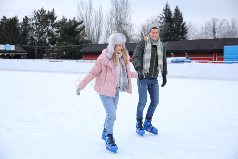 Happy Couple Skating Along Ice Rink Outdoors Stock Image - Image of ...