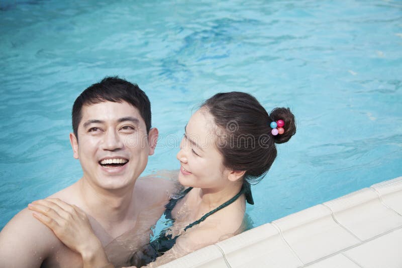 Happy Couple Smiling and Relaxing in the Pool Stock Photo - Image of ...